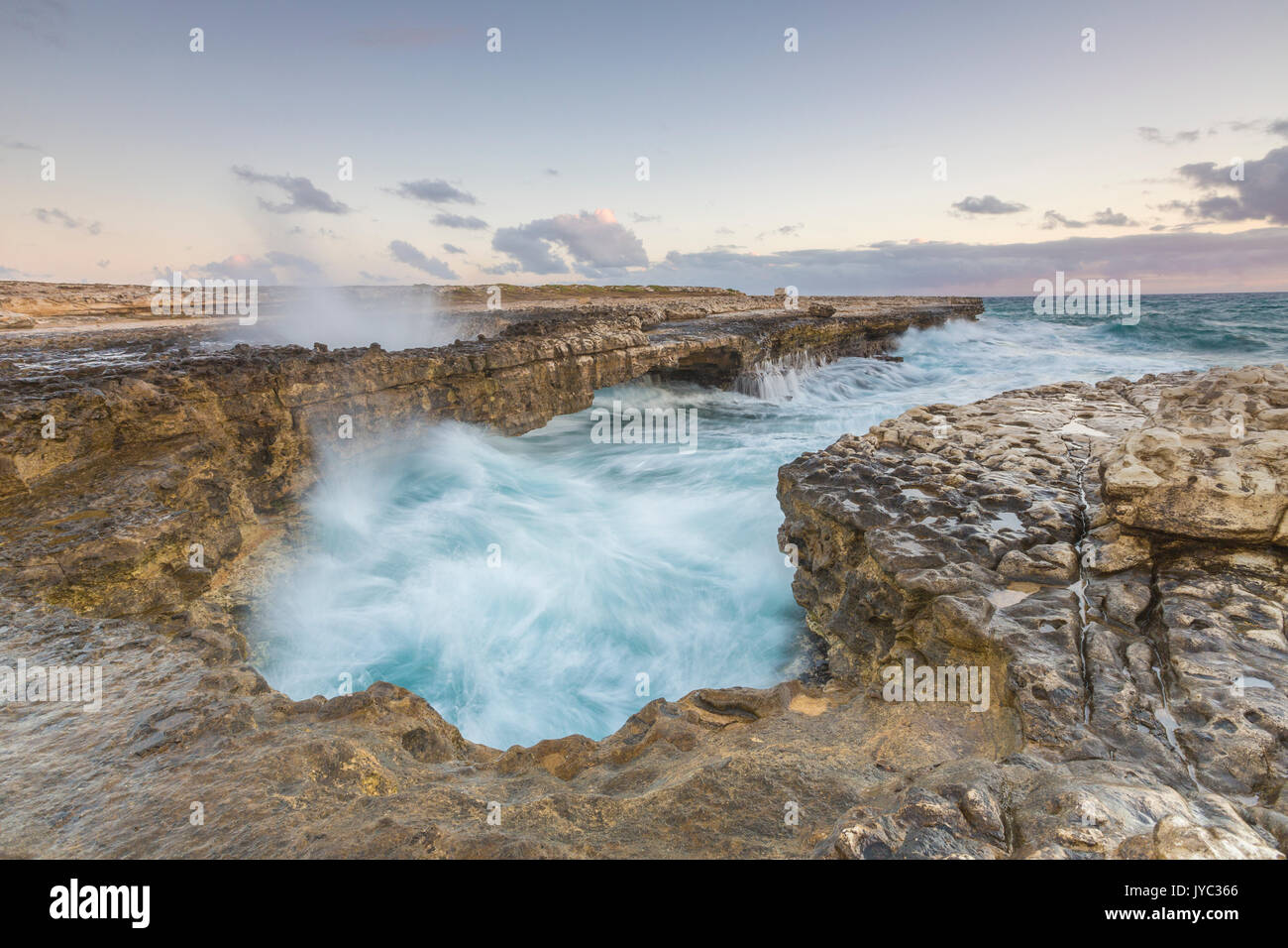 Waves of the rough sea crashing on the cliffs of Devil's Bridge ...