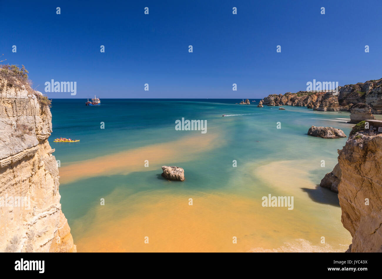 Canoes in the turquoise water of the Atlantic Ocean surrounding Praia ...