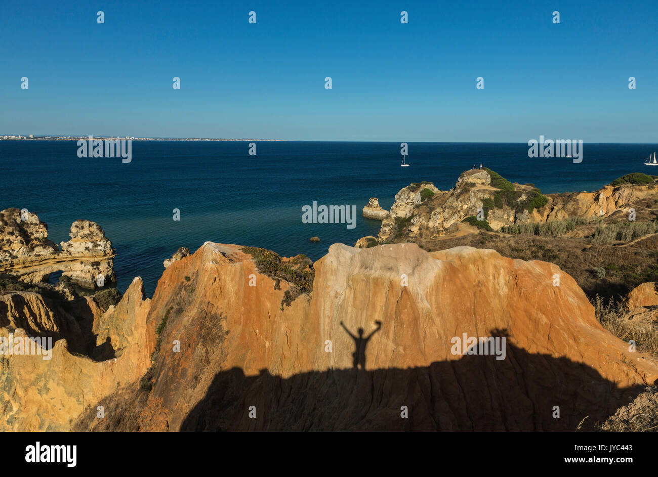 The shadow of the silhouette of a hiker reflected on the cliffs ...