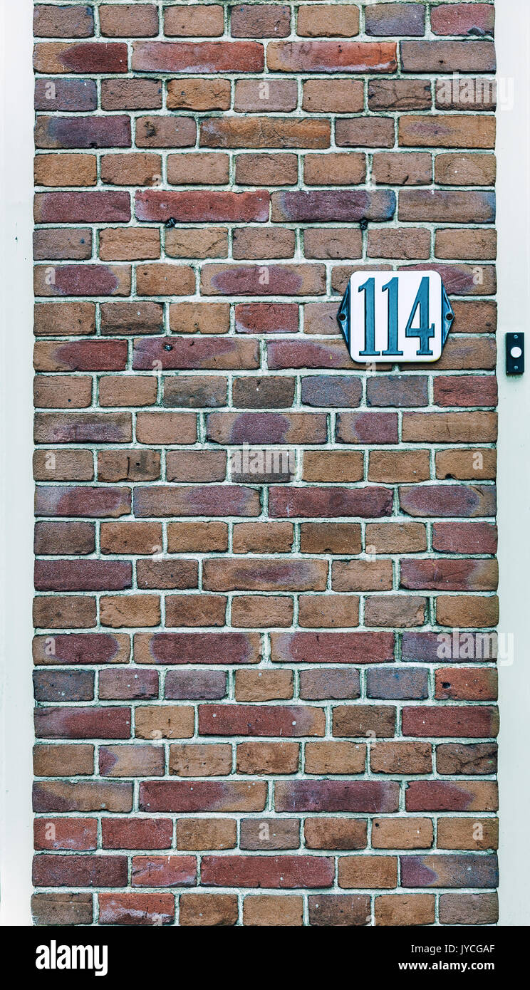 the door number on the brick wall texture Stock Photo - Alamy