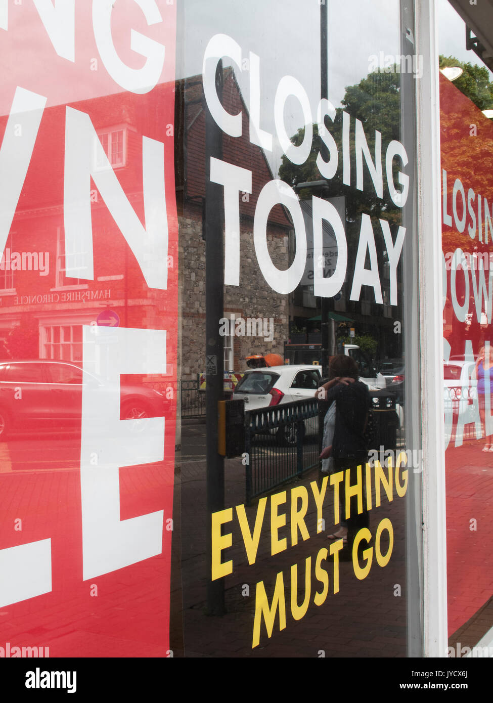 Closing today everything must go and sale posters in retail shop window ...