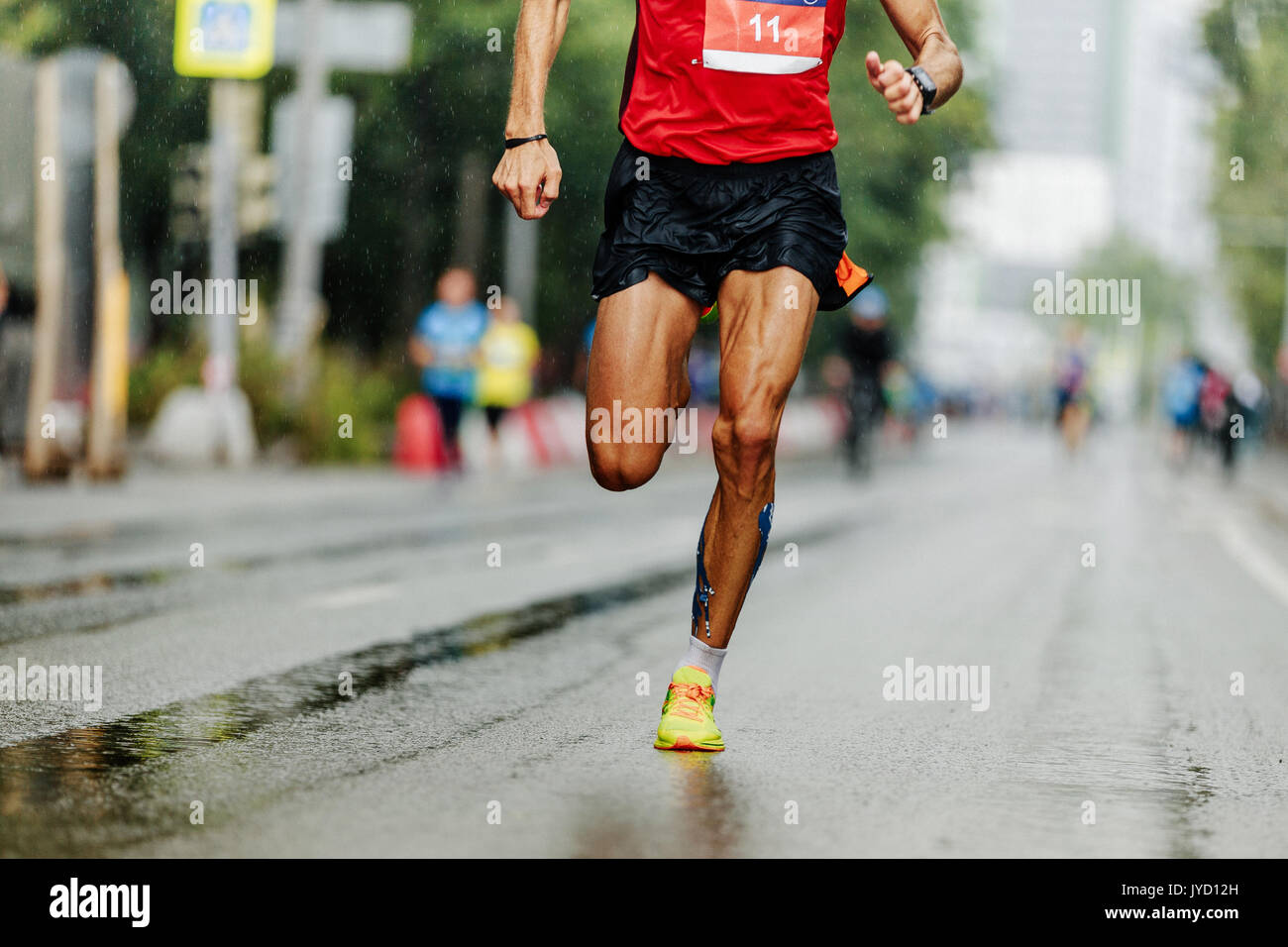 leader athlete runner running city marathon in rain Stock Photo - Alamy