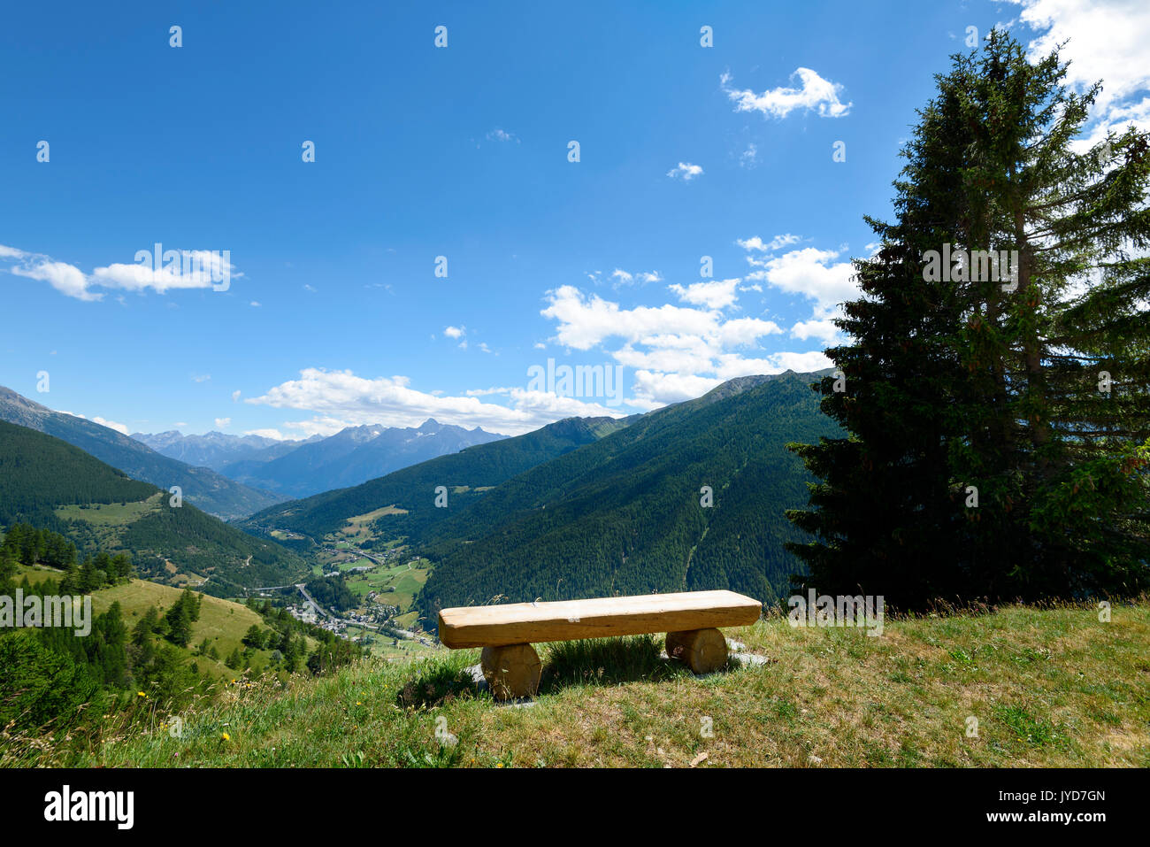 Bench and a curved country road in a mountain landscape Stock Photo - Alamy