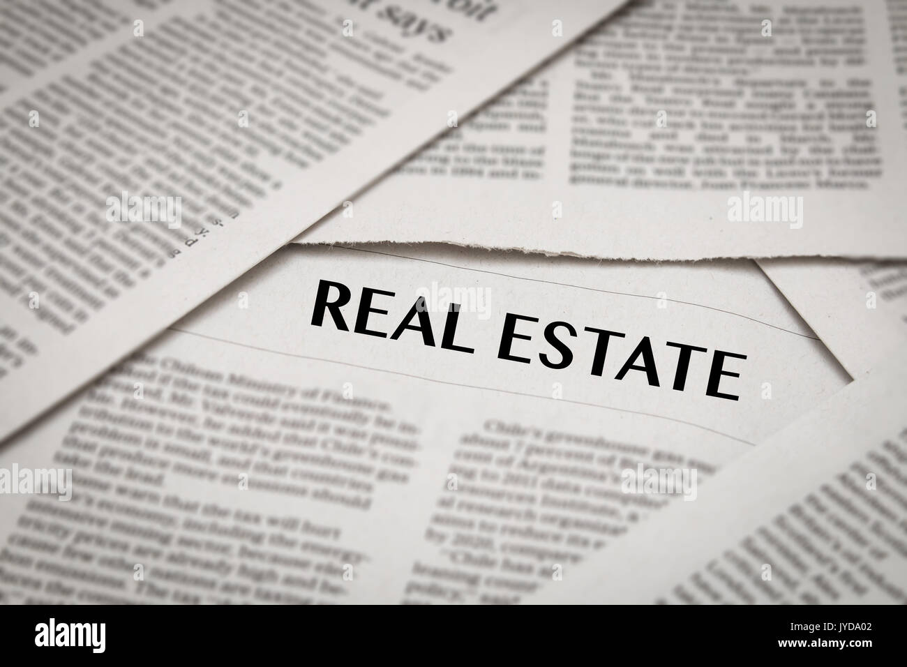 real estate headline on newspaper background Stock Photo - Alamy