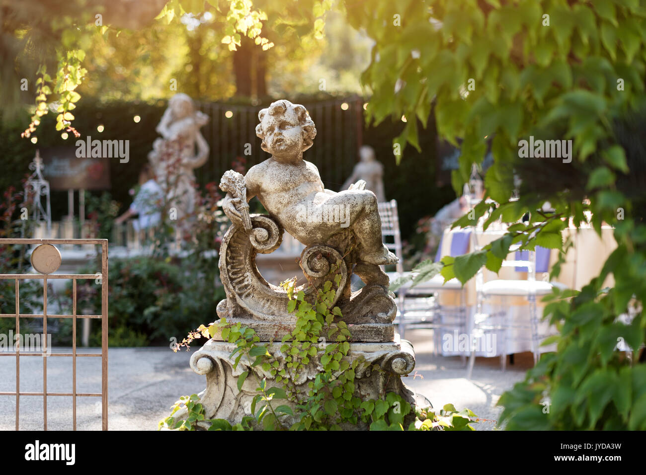 Cupid sculpture in the garden, cute cupid statue in the outdoor ...