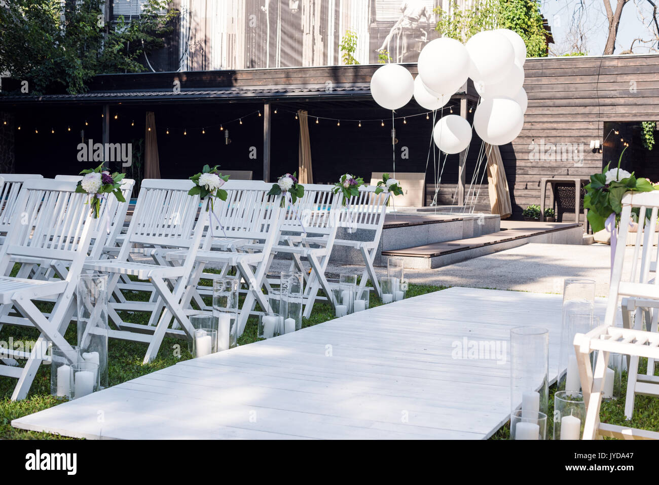 Beautiful wedding set up. Wedding ceremony in the garden. White wooden ...