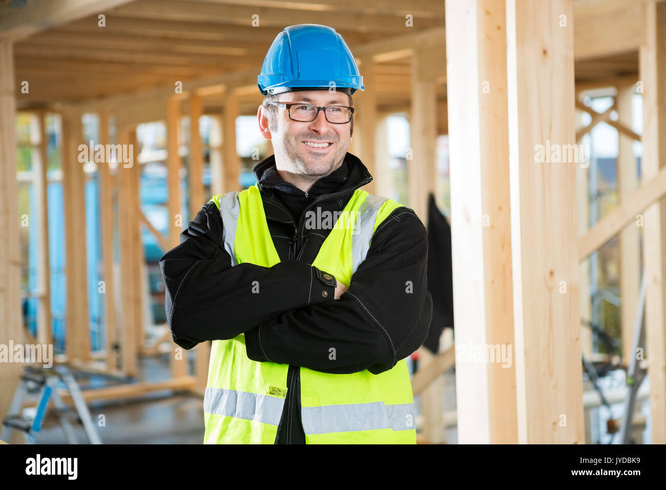 Carpenter Standing Arms Crossed While Looking Away Stock Photo - Alamy