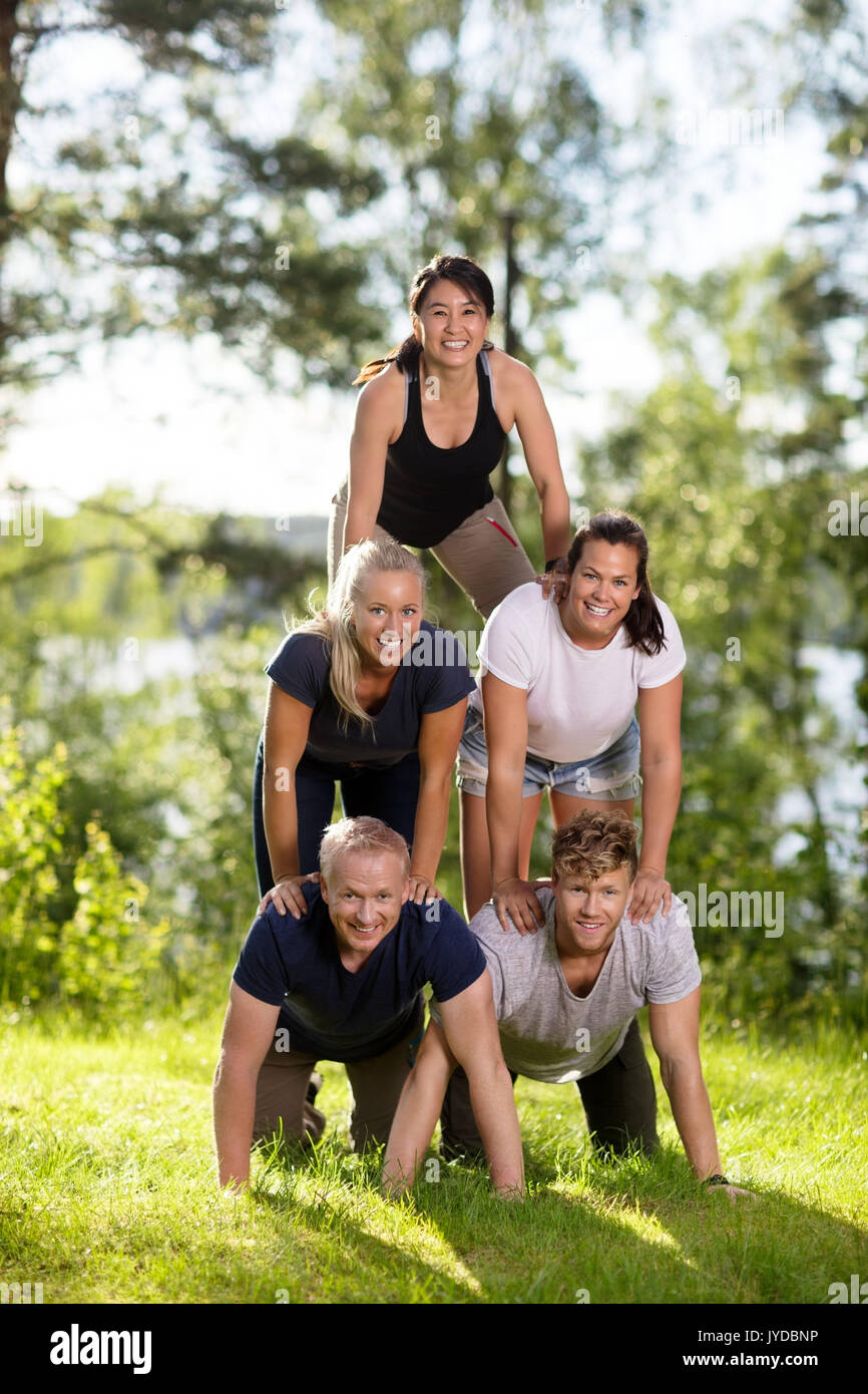 Portrait Of Multiethnic Business People Making Human Pyramid On Stock ...