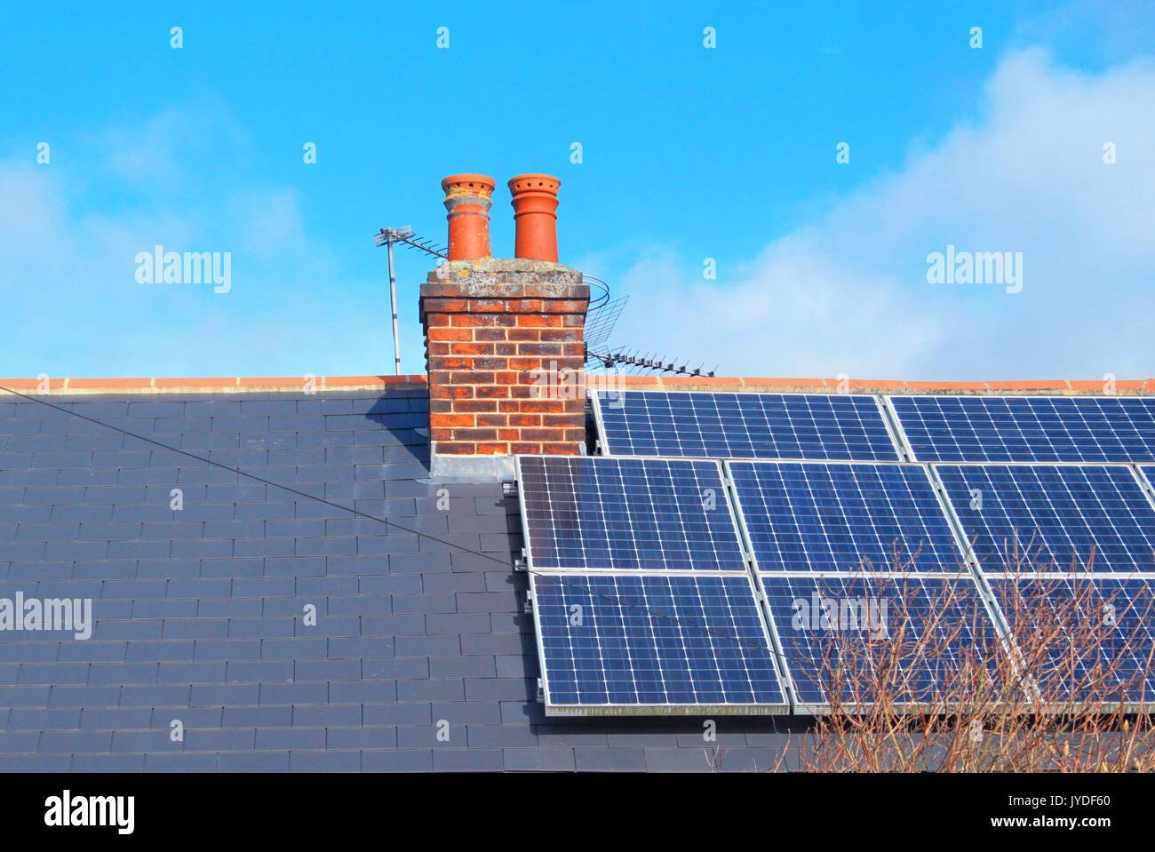 English chimney on the roof with solar panels and blue sunny sky Stock ...