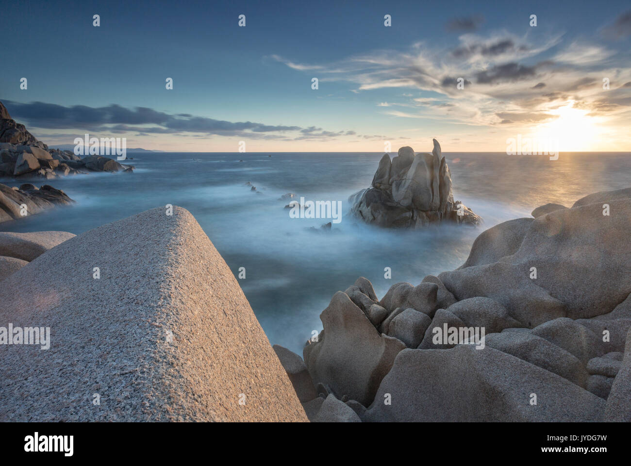 Sunset on modeled cliffs by wind framing blue sea Capo Testa Santa ...