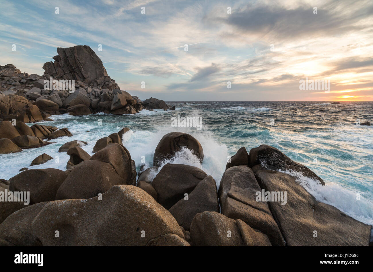 Sunset on modeled cliffs by wind framing blue sea Capo Testa Santa ...