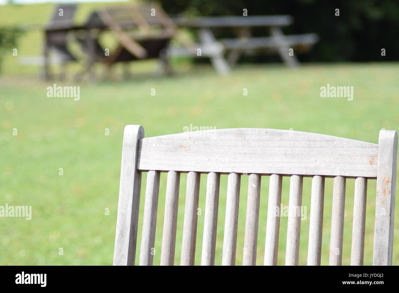 Garden chair back with lawn background .Silvered hardwood garden chair ...