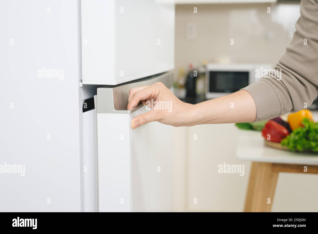 Woman opening fridge door hi-res stock photography and images - Alamy