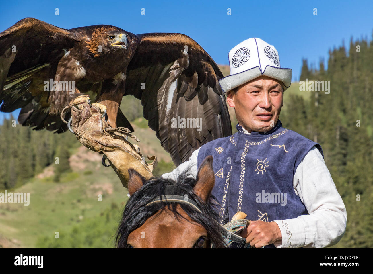Eagle Hunter holds his eagles on horseback, ready to take flight in ...