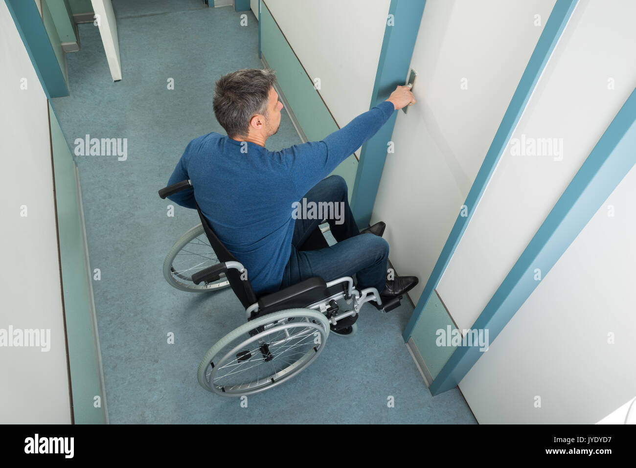 High Angle View Of A Man Sitting On Wheelchair Opening Door Stock Photo ...