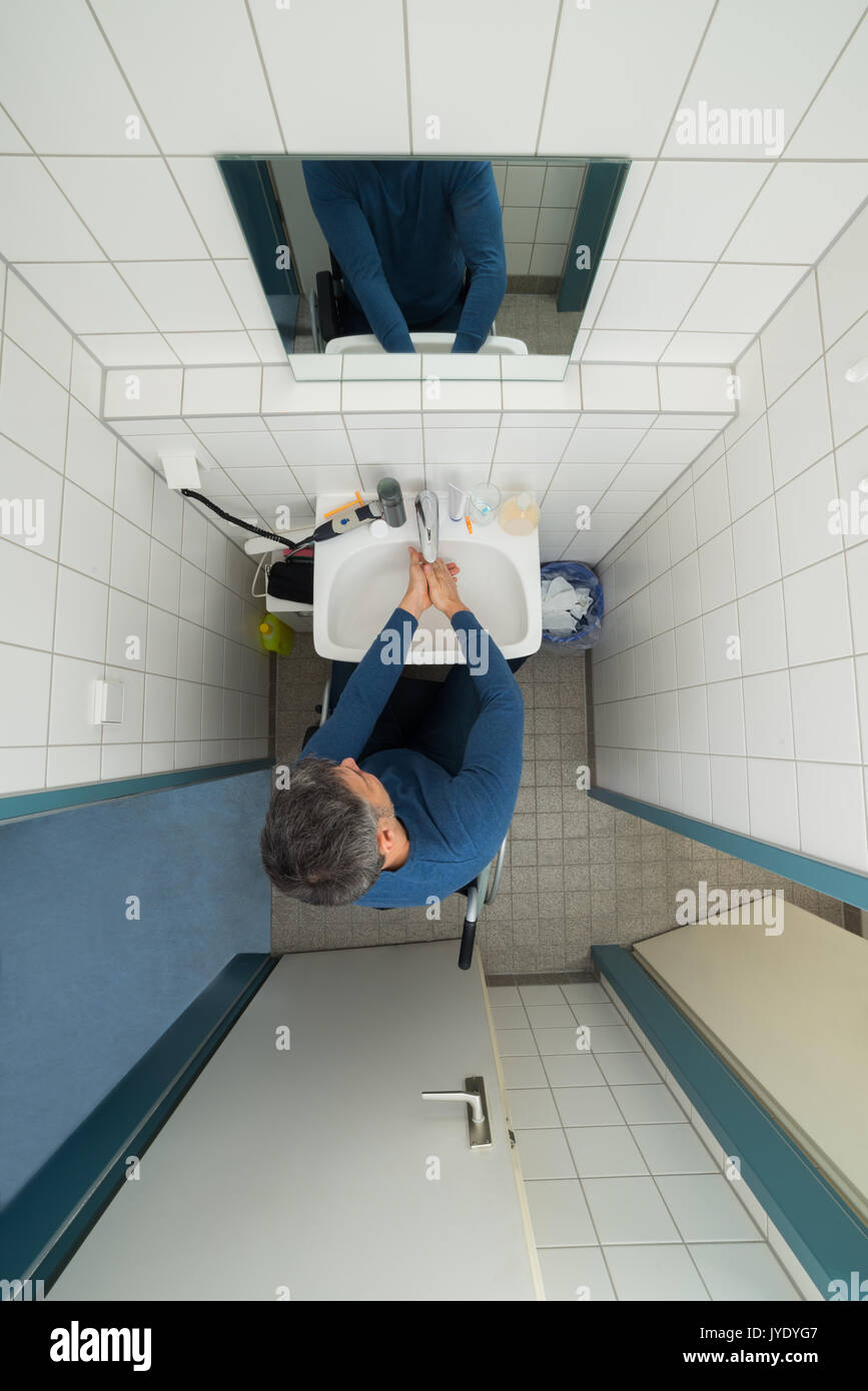 Disabled man in bathroom washing hi-res stock photography and images ...