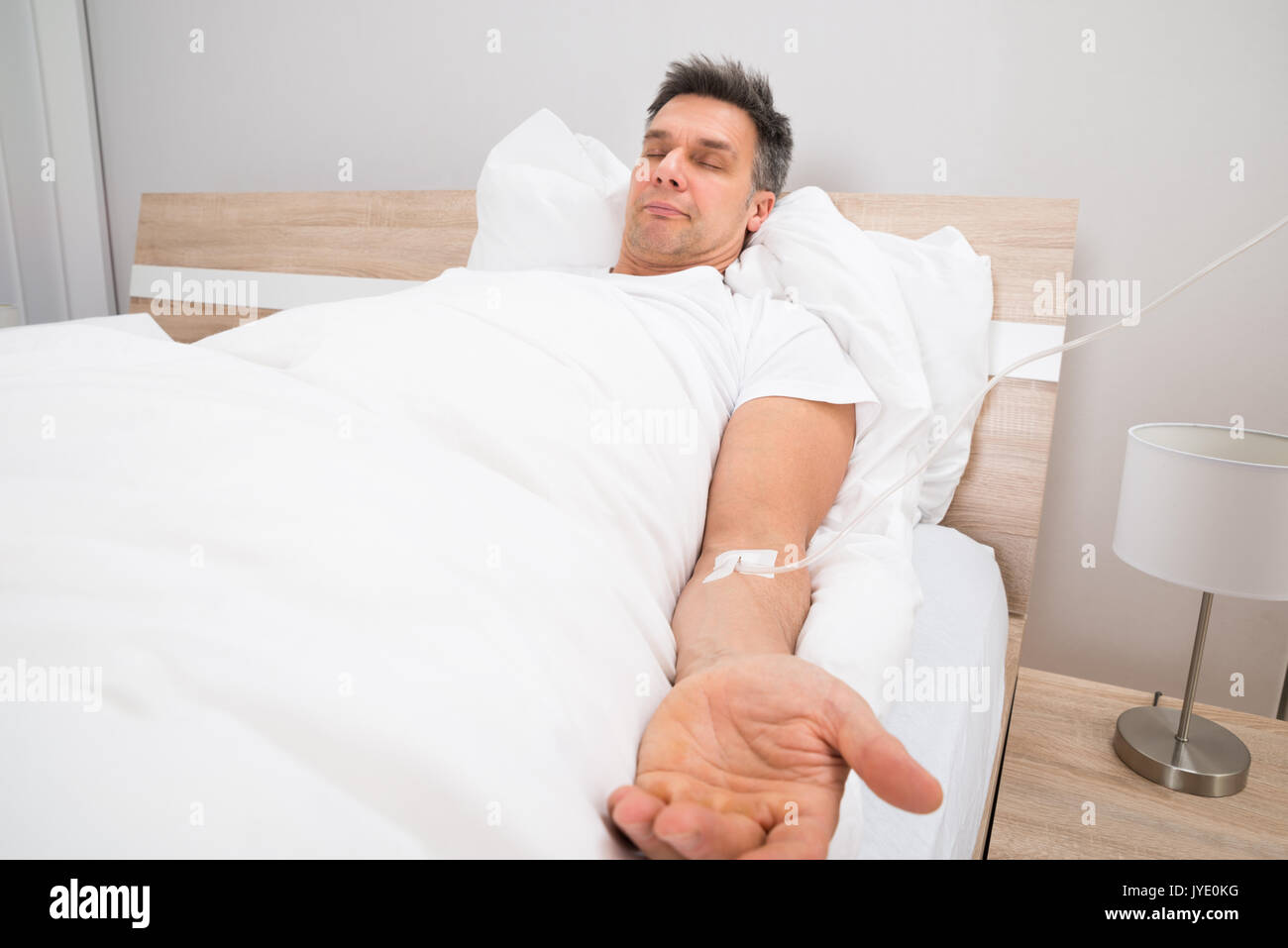 Patient Resting On Bed With Iv Drip In Hospital Stock Photo - Alamy