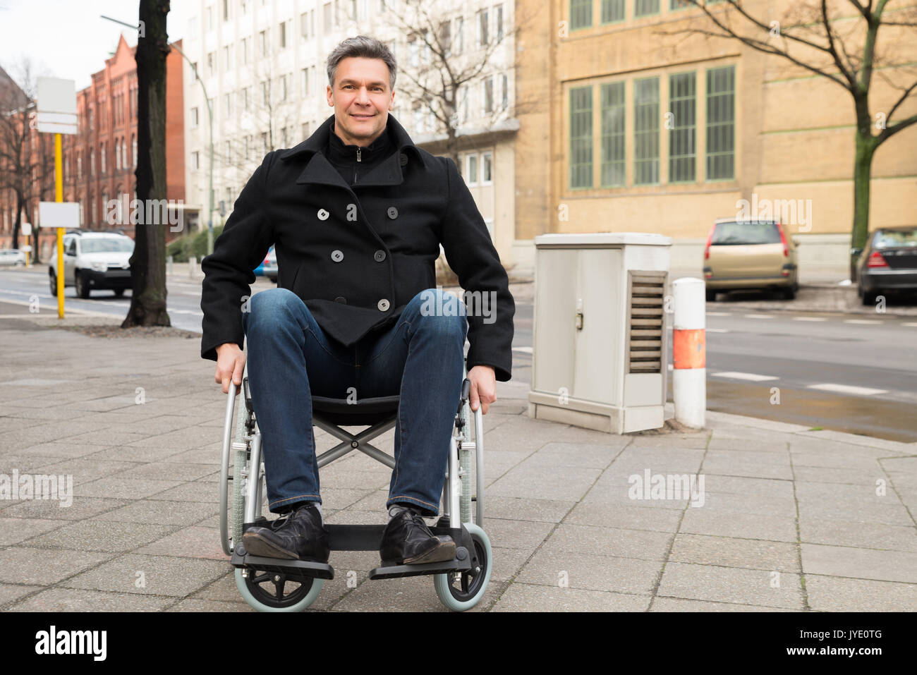 Portrait Of A Smiling Disabled Man On Wheelchair In City Stock Photo ...