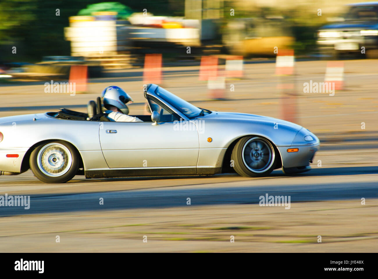 Stunt drivers race and drift their modified Japanese cars on a sunny ...