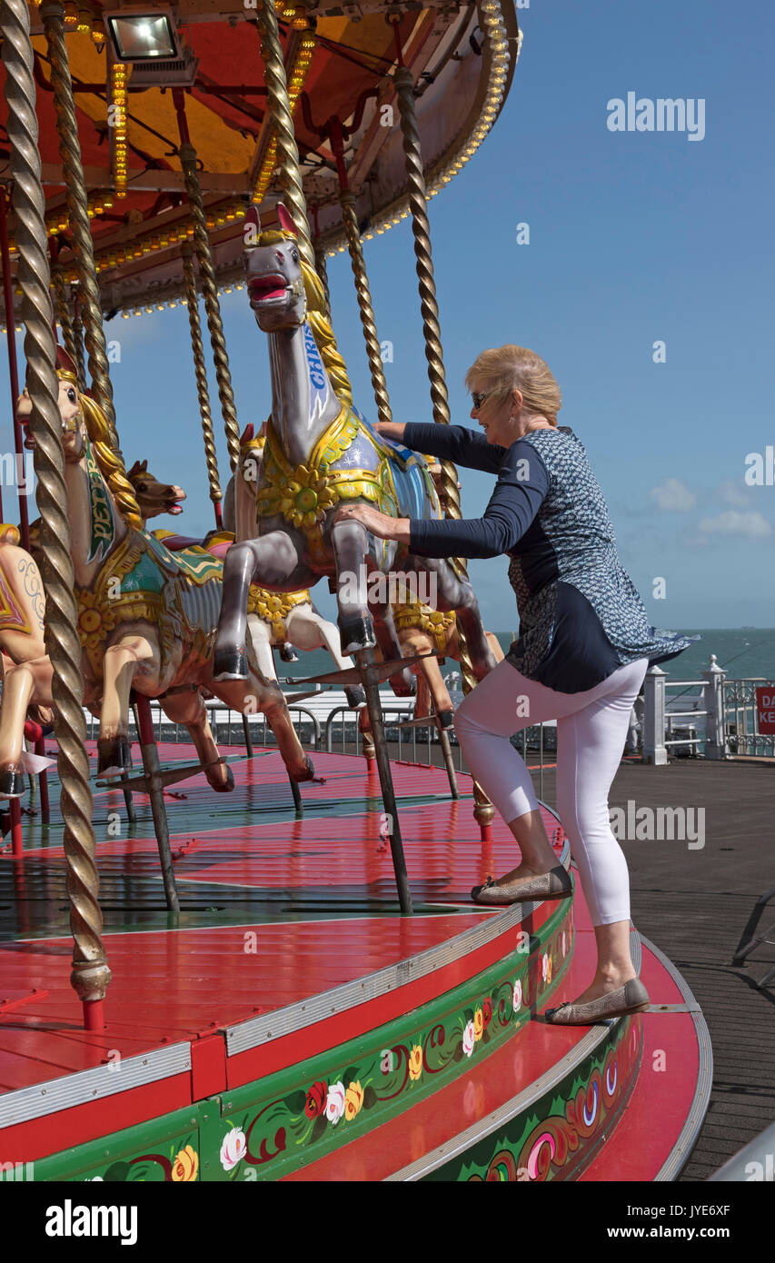 Women riding on carousel hi-res stock photography and images - Alamy
