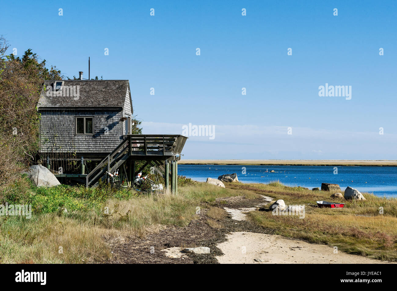 Quaint beach cottage on stilts with rowboat along Weeset Point, Nauset ...