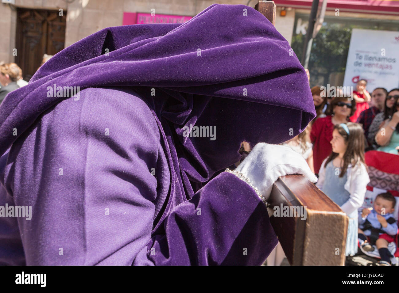 Penitent praying on his cross in front of church during Holy week ...