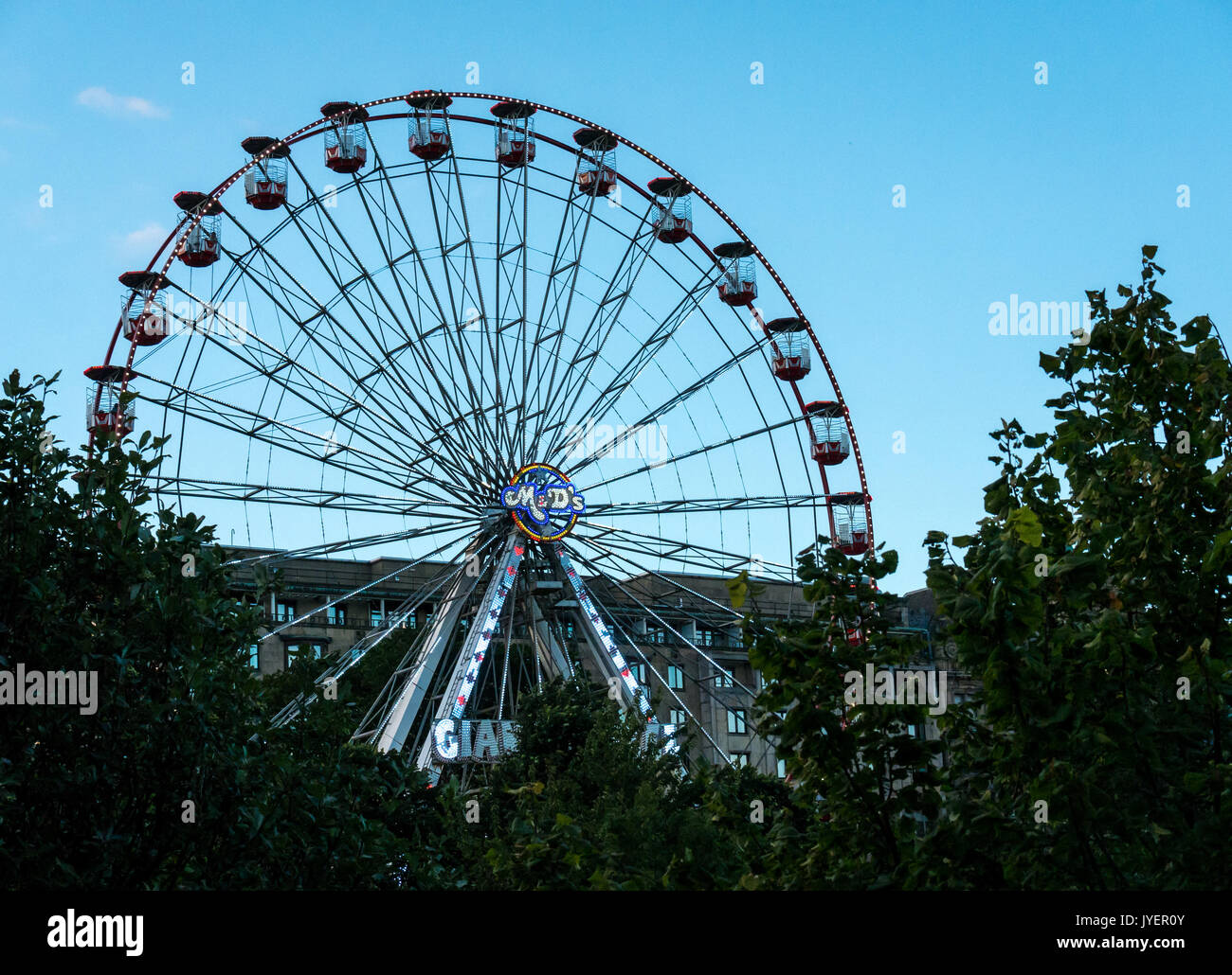 View of lit up M&Ds Festival Big Ferris Wheel in evening light during ...