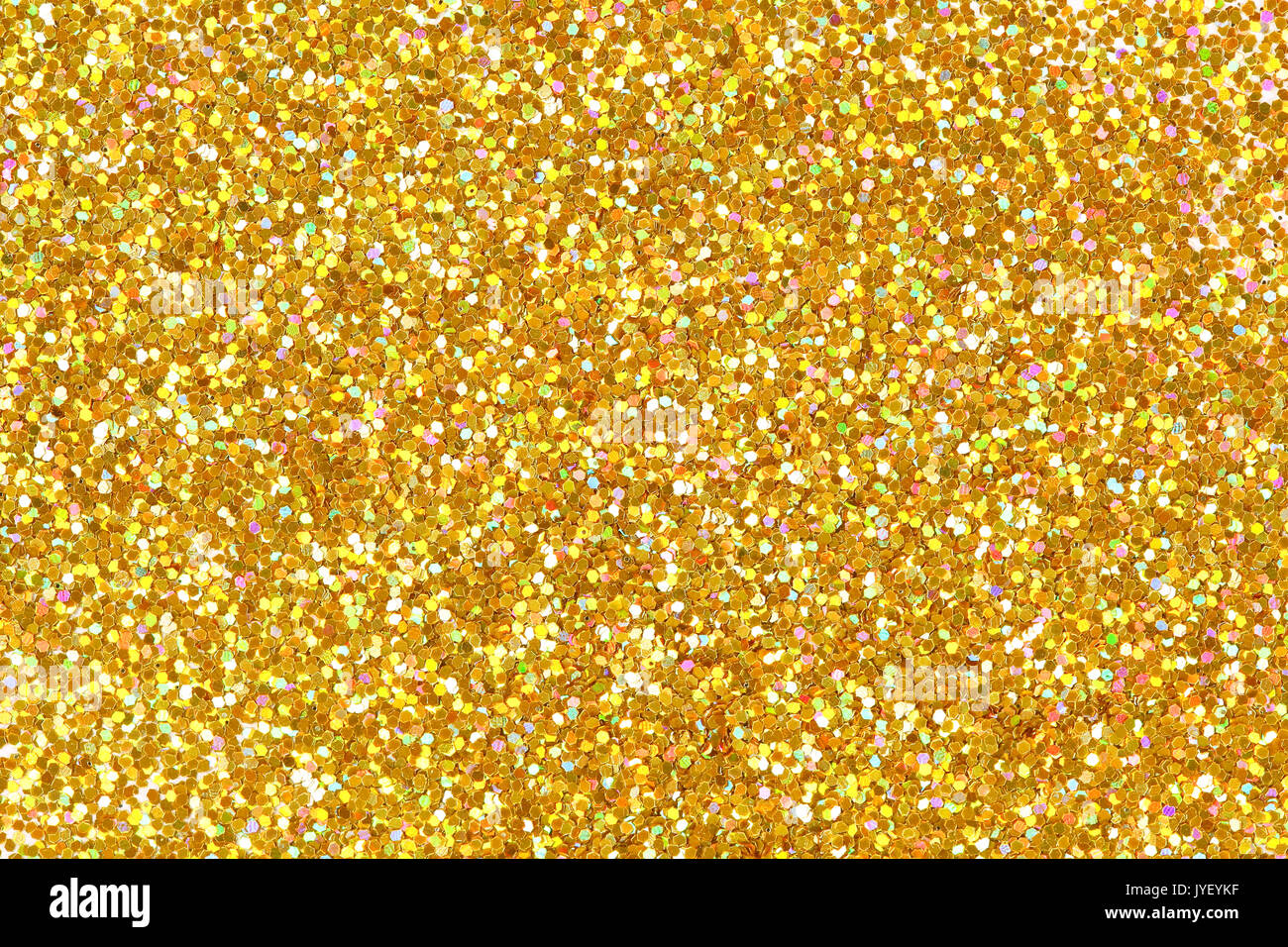 Detailed texture of glittering golden dust surface. High resolution ...