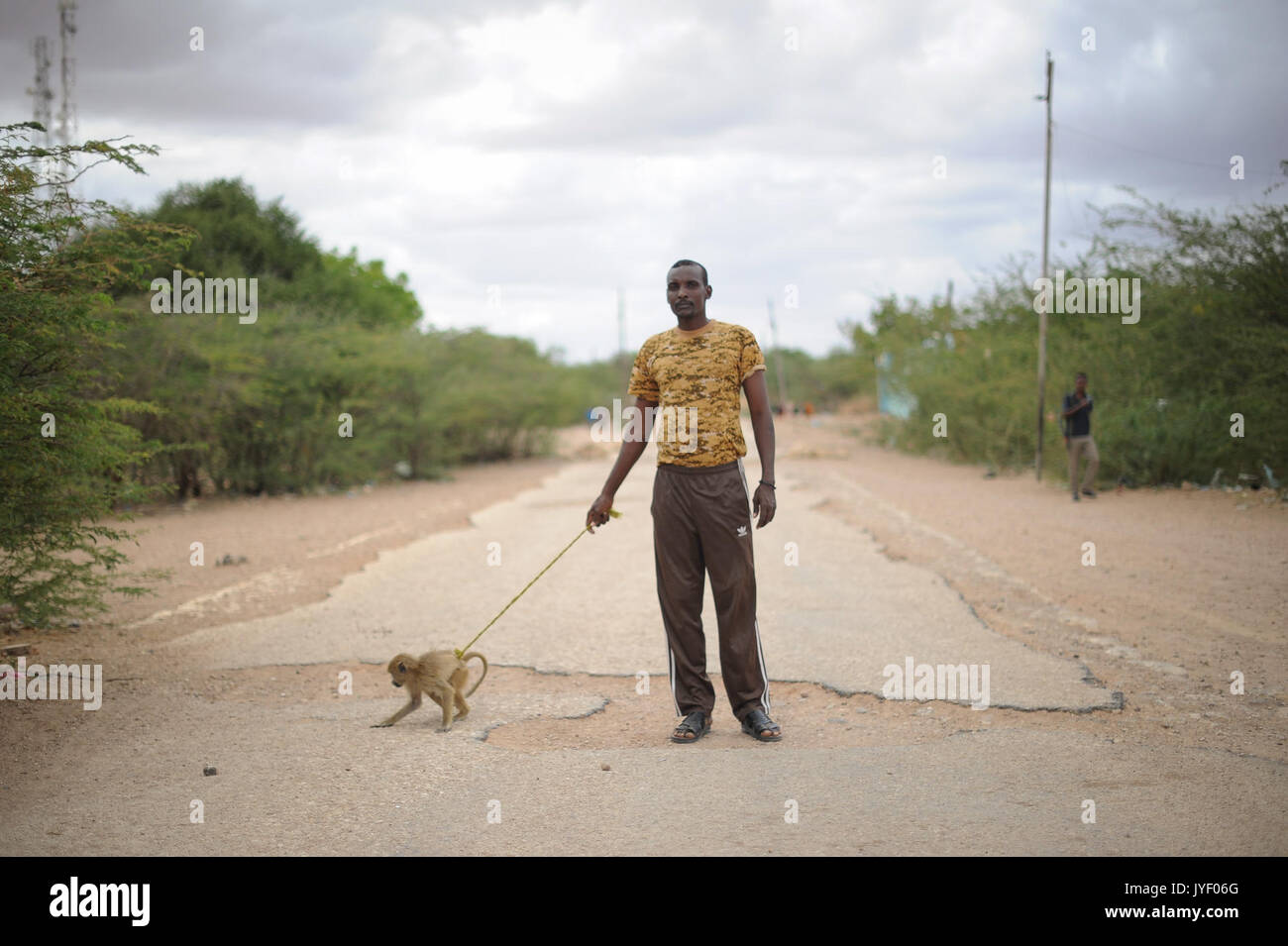 A member of the Somali National Army and his pet monkey stand in the ...