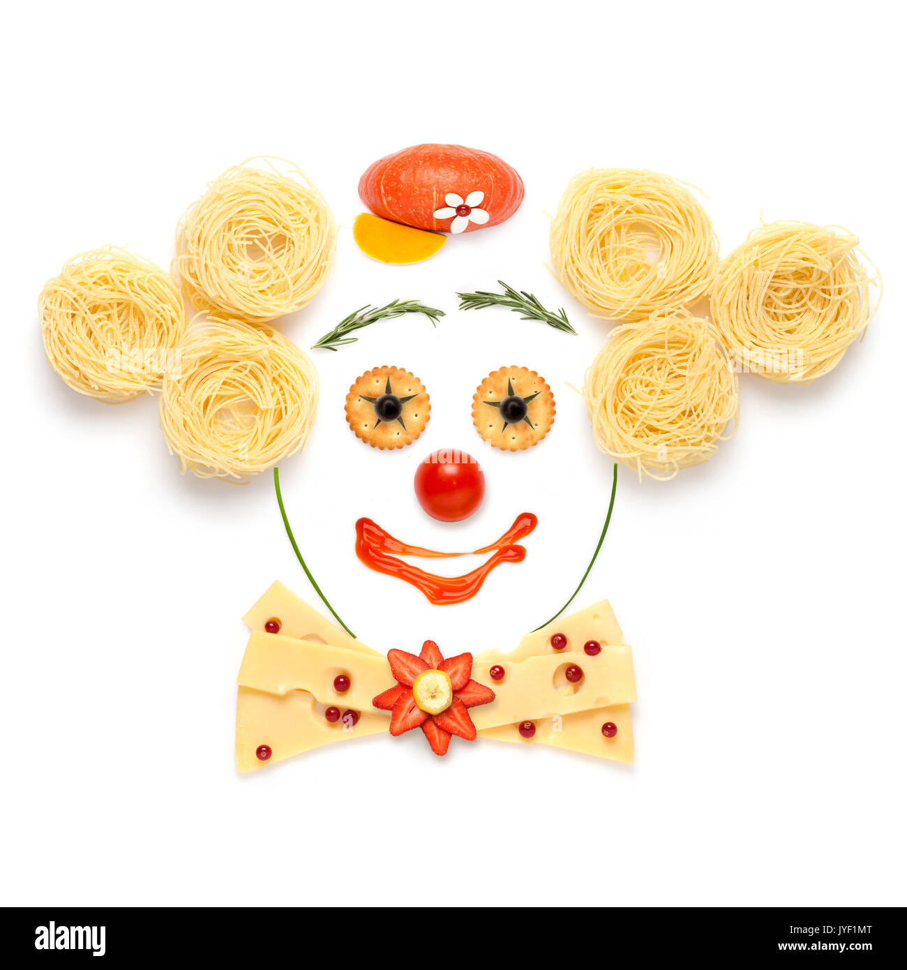 Creative food concept photo of joyful clown made of cheese and noodles ...