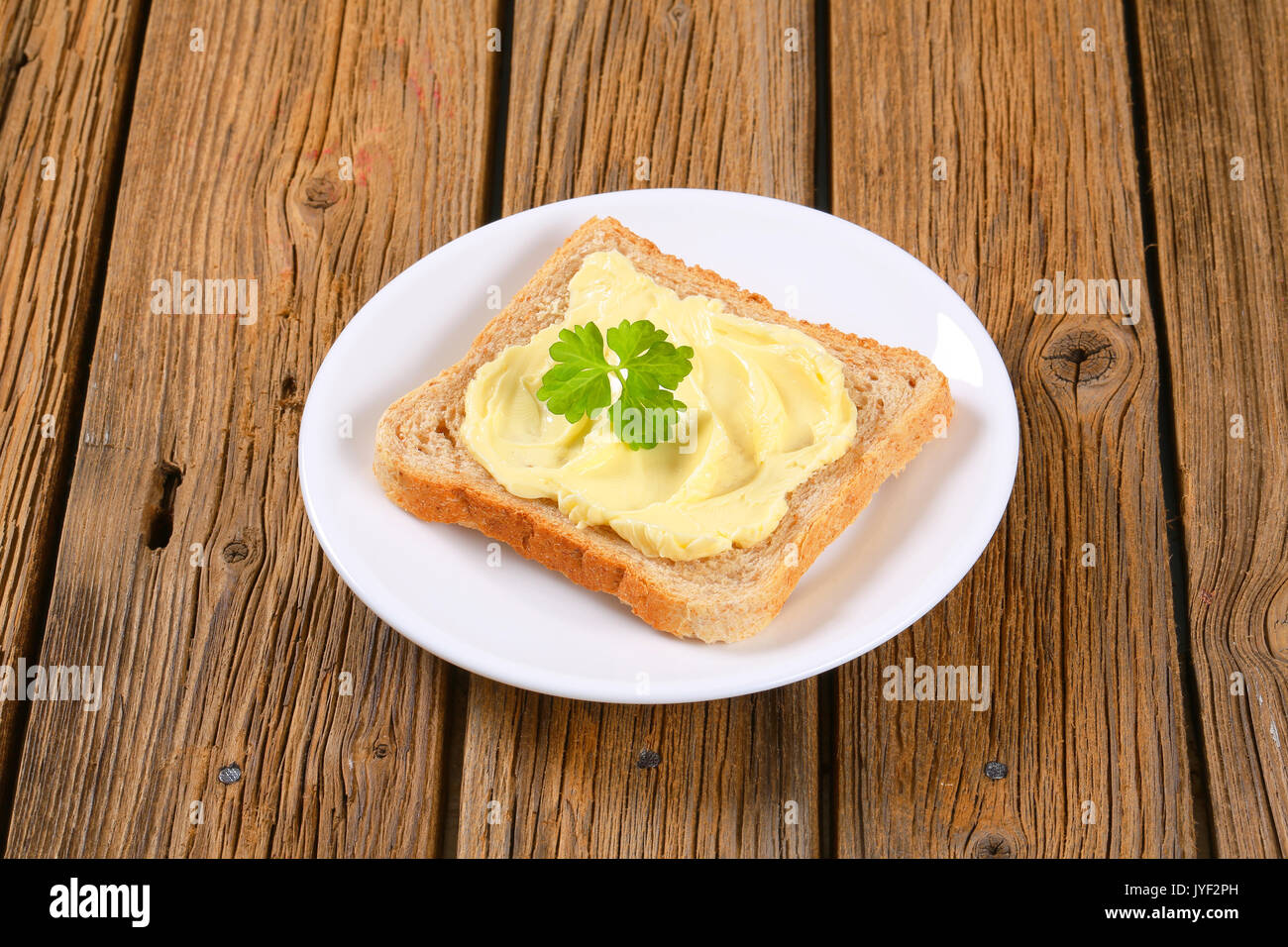 Slice of toast bread with butter on a plate Stock Photo - Alamy
