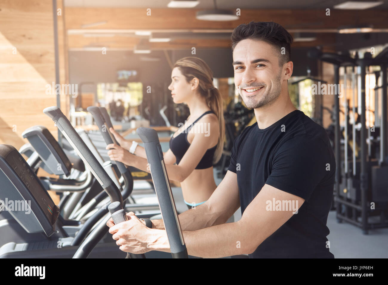 Young man and woman exercise together cardio workout Stock Photo - Alamy