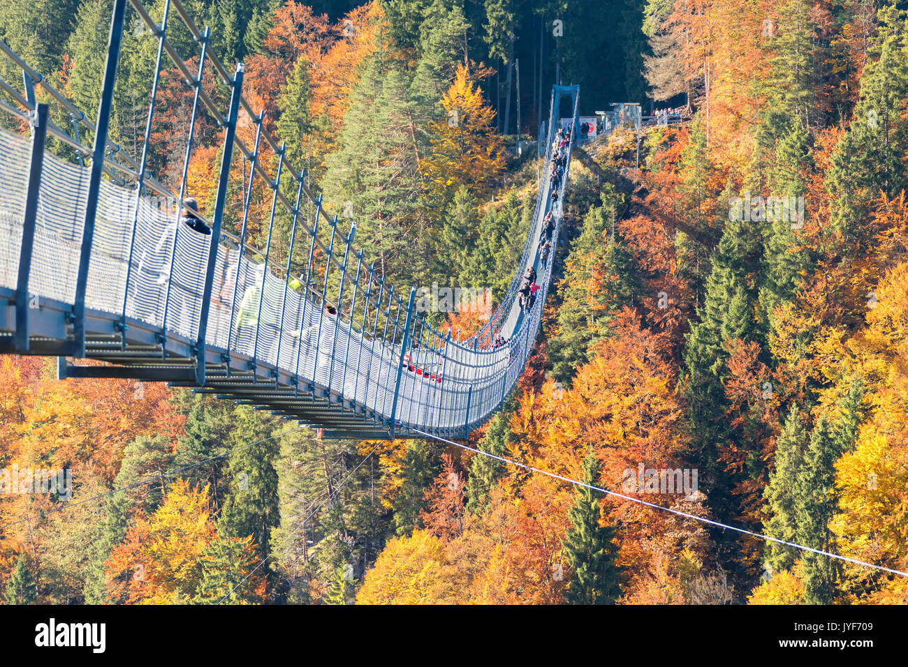 Tourists on the suspension bridge called Highline 179 framed by ...