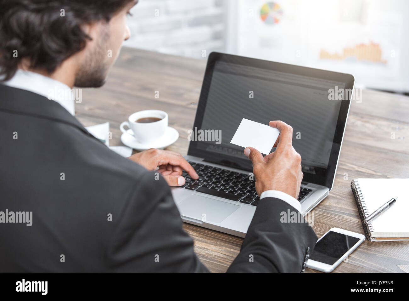 Male person working in the office holding business card Stock Photo - Alamy