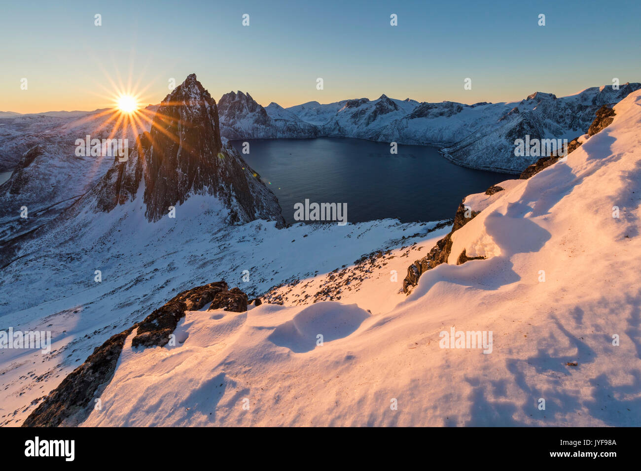 First lights of sunrise on Mount Segla and Mefjorden framed by the ...