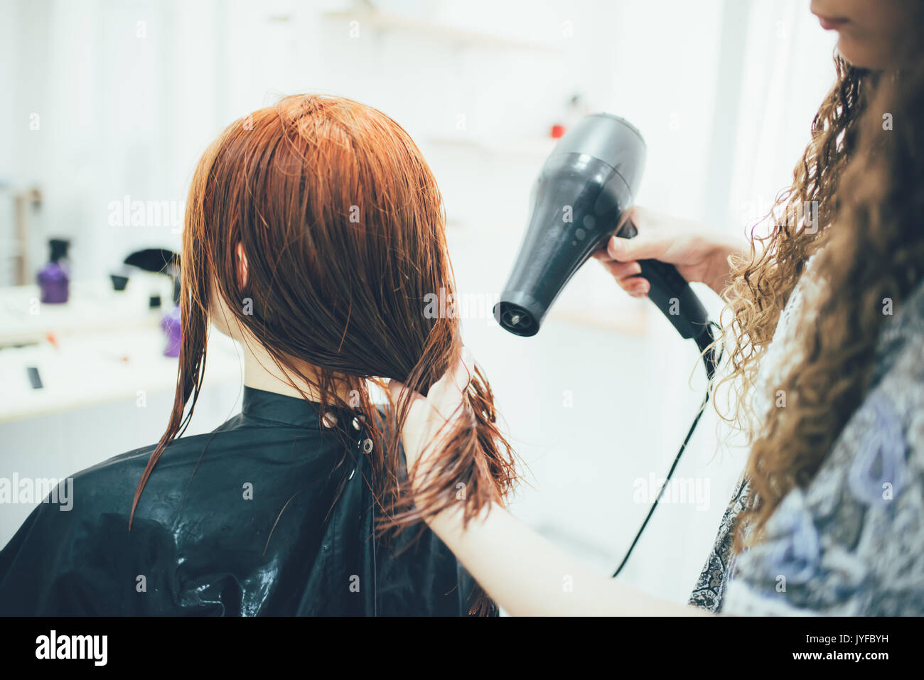 Stylist working in the beauty salon, haircut and hair styling Stock ...