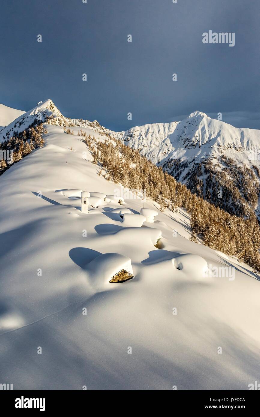 Italy, Italian Alps, Lombardy, The huts and the bell tower of Alpe Cima ...