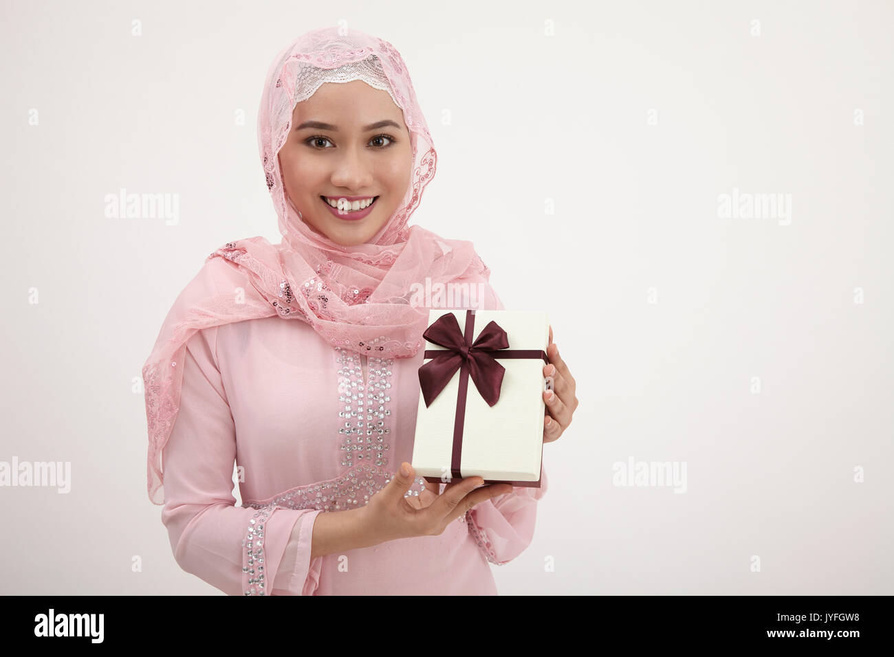 malay woman with tudung holding a present Stock Photo - Alamy