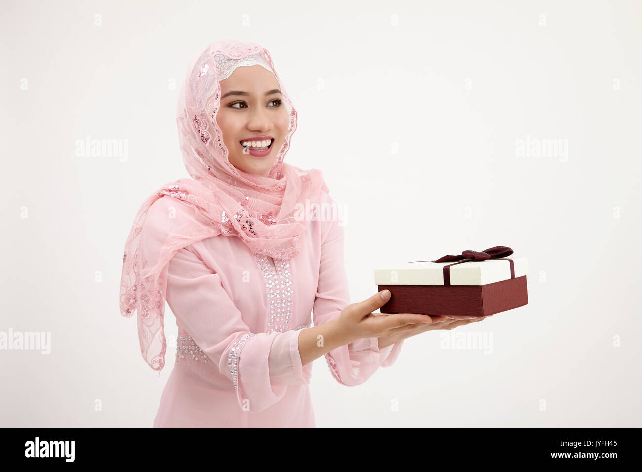 malay woman with tudung holding a present Stock Photo - Alamy