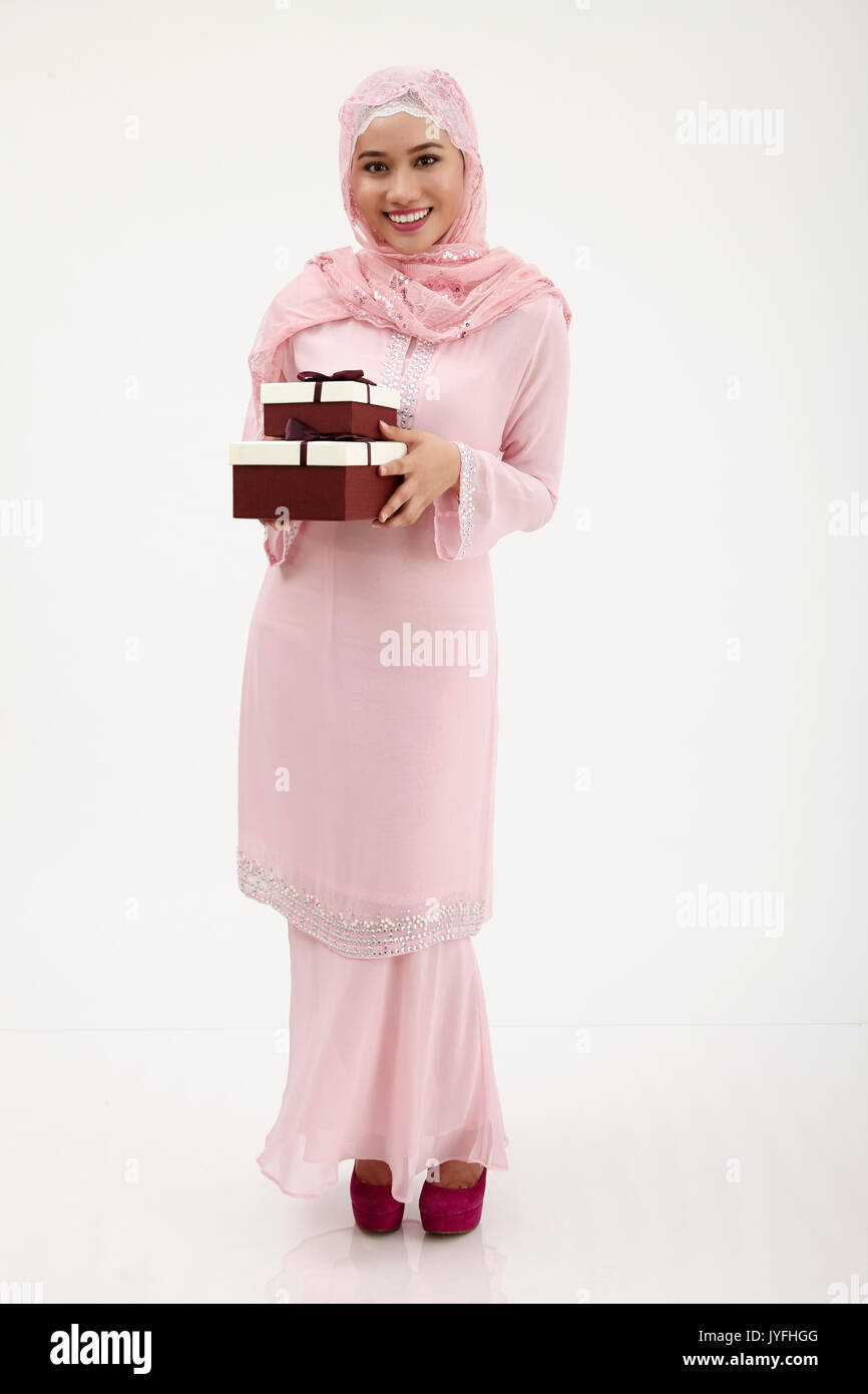 malay woman with tudung holding a present Stock Photo - Alamy