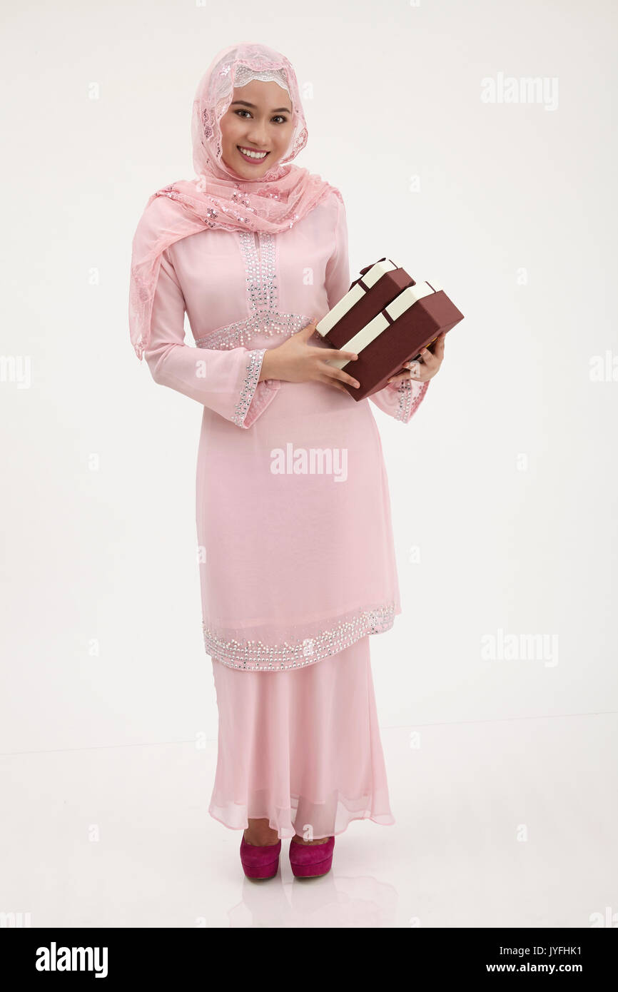 malay woman with tudung holding a present Stock Photo - Alamy