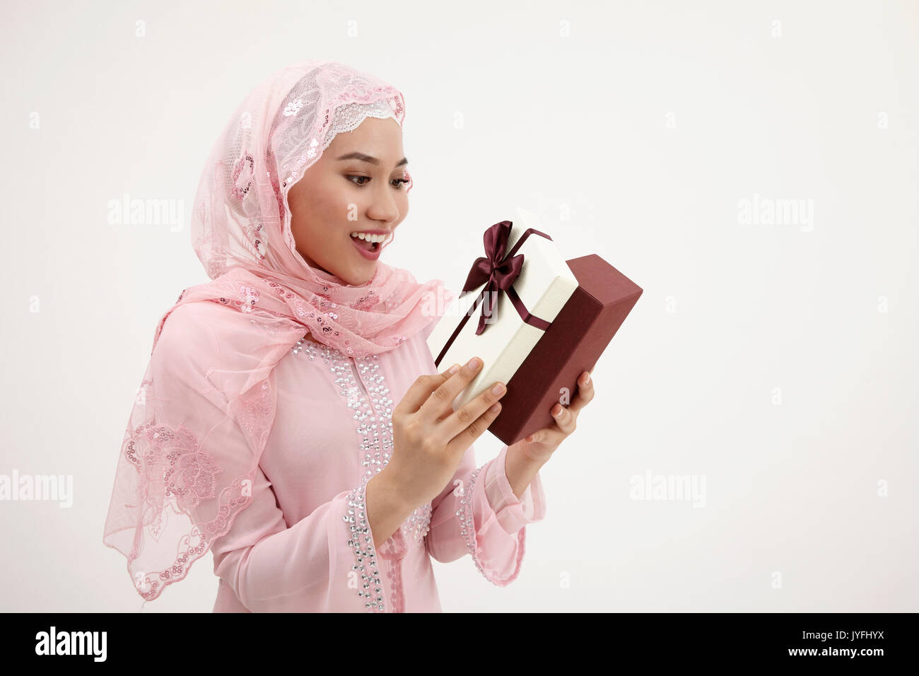 malay woman with tudung holding a present Stock Photo - Alamy
