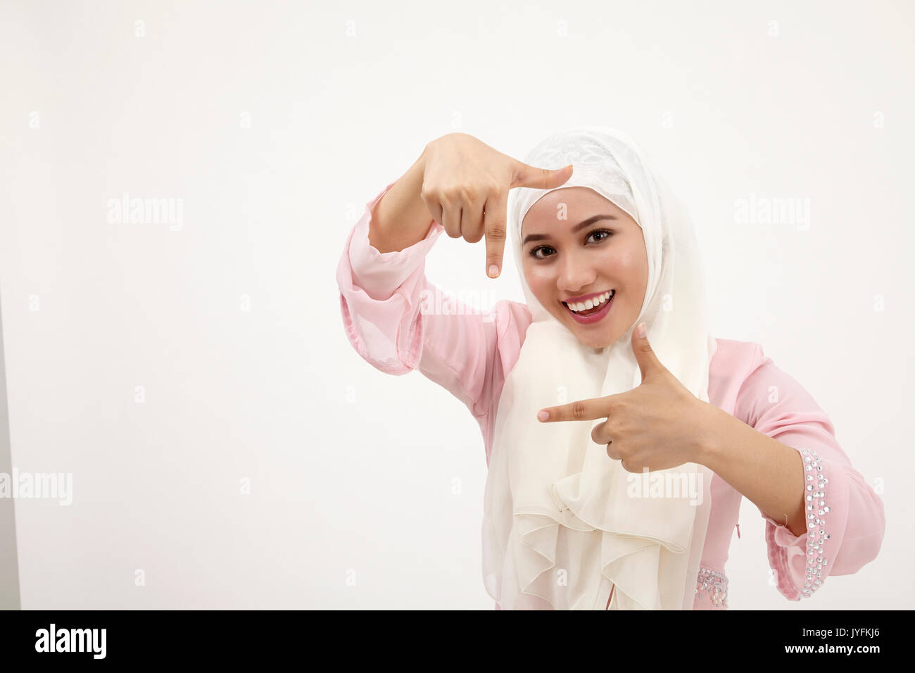 malay woman with tudung with hands showing cropping composition gesture ...
