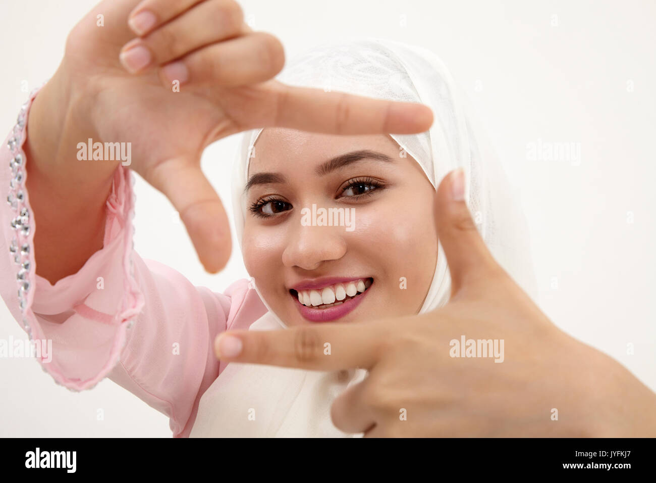 malay woman with tudung with hands showing cropping composition gesture ...