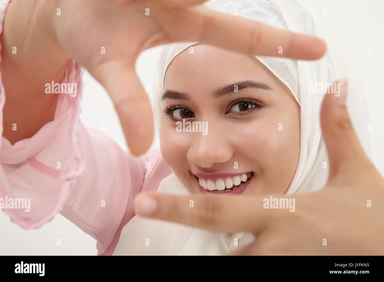 malay woman with tudung with hands showing cropping composition gesture ...