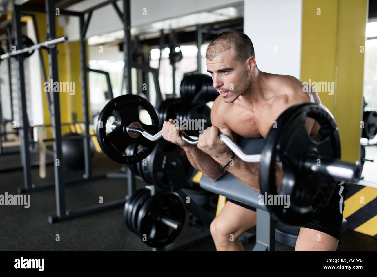Athlete muscular bodybuilder in gym training biceps Stock Photo - Alamy