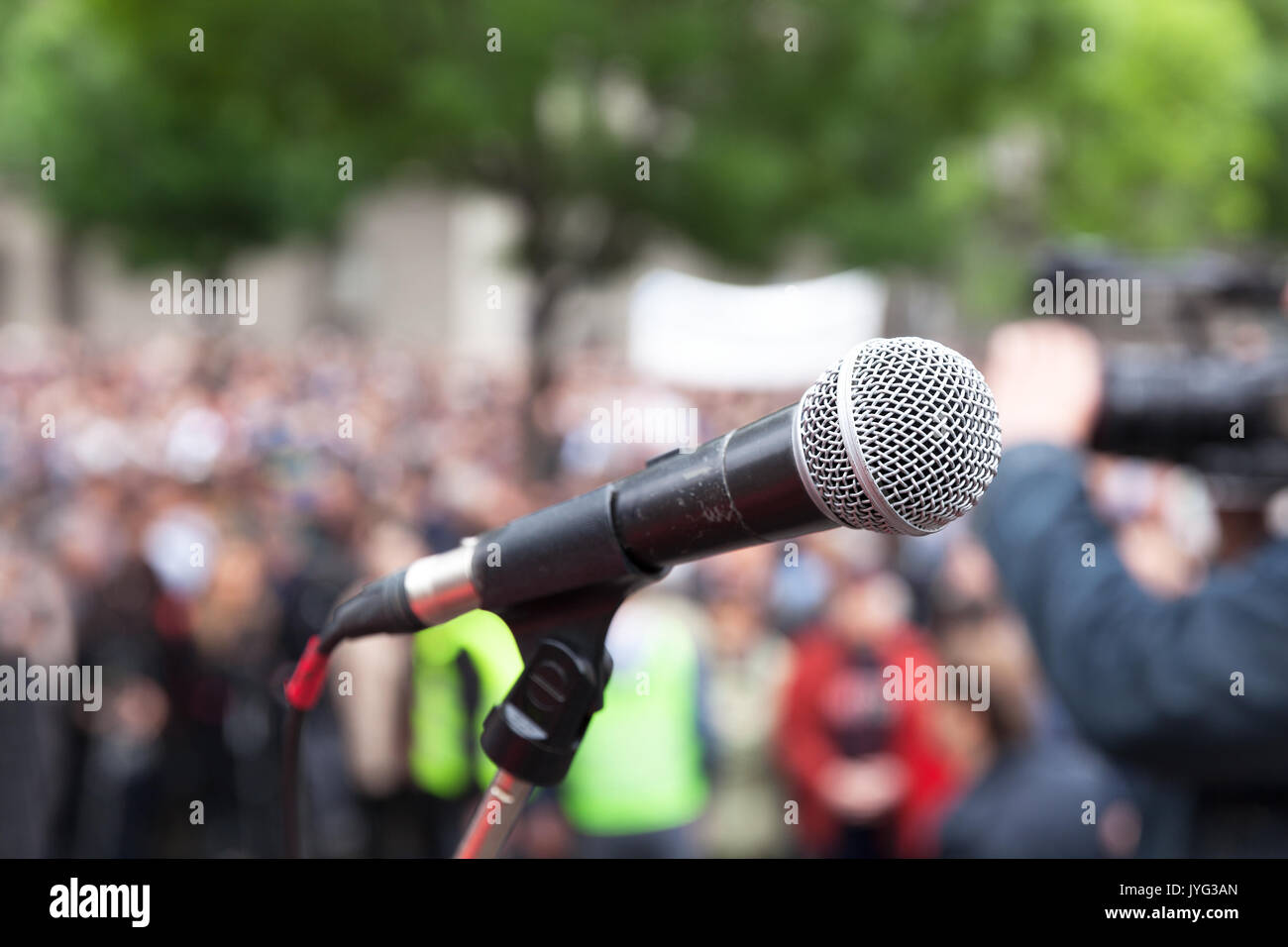 Microphone in focus against blurred crowd Stock Photo - Alamy