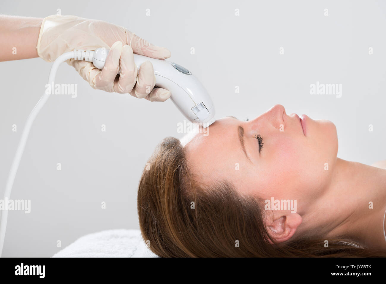 Young Woman Receiving Laser Hair Removal Treatment At Beauty Center ...