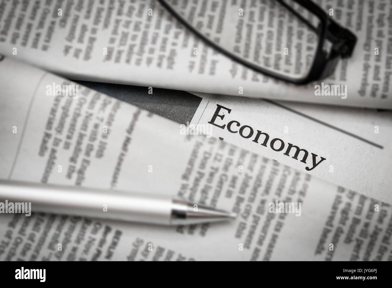 economy issue on newspaper background Stock Photo - Alamy