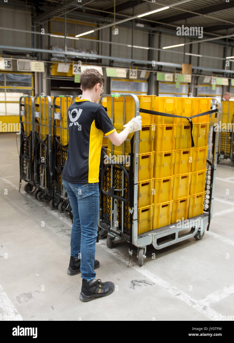 An employee of the Deutsche Post (German mail) works at the letter ...
